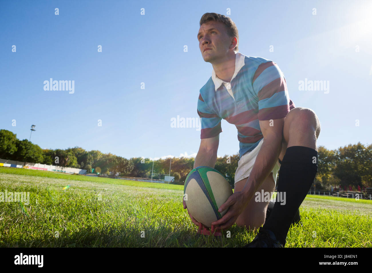 Low angle view of rugby player getting ready to kick for goal on ...