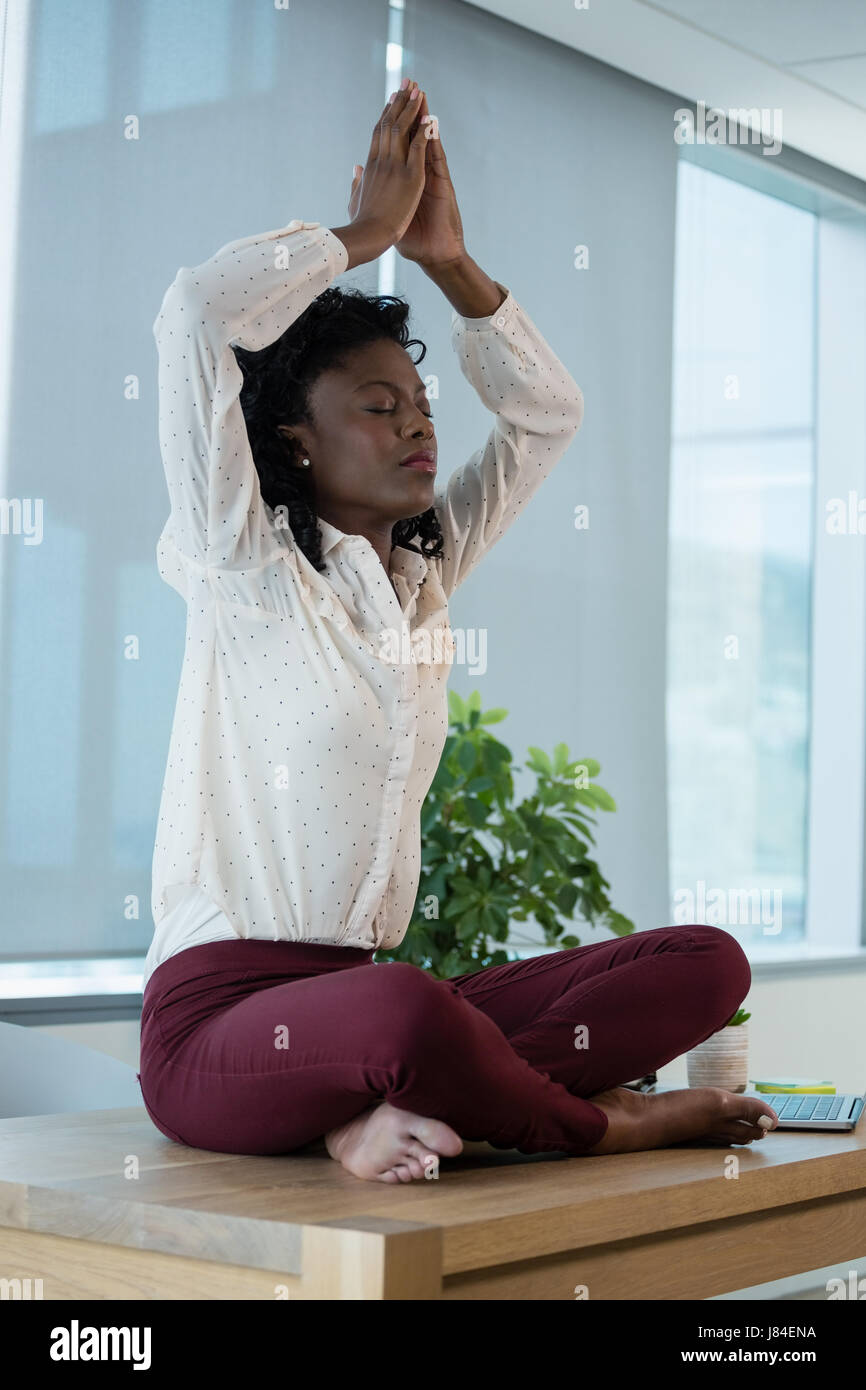 Business woman meditating on desk hi-res stock photography and images ...
