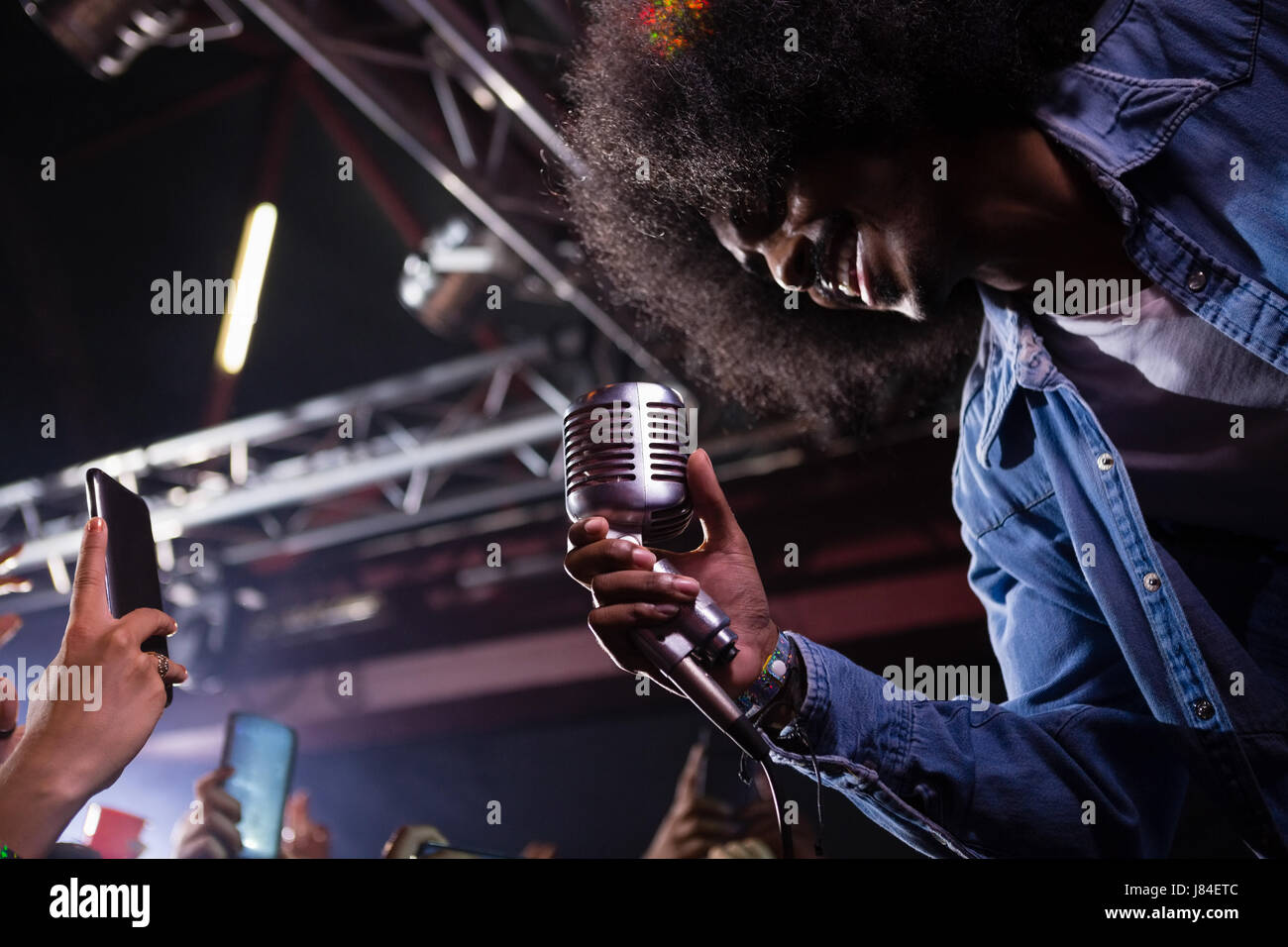 Singer performing on stage in nightclub Stock Photo - Alamy