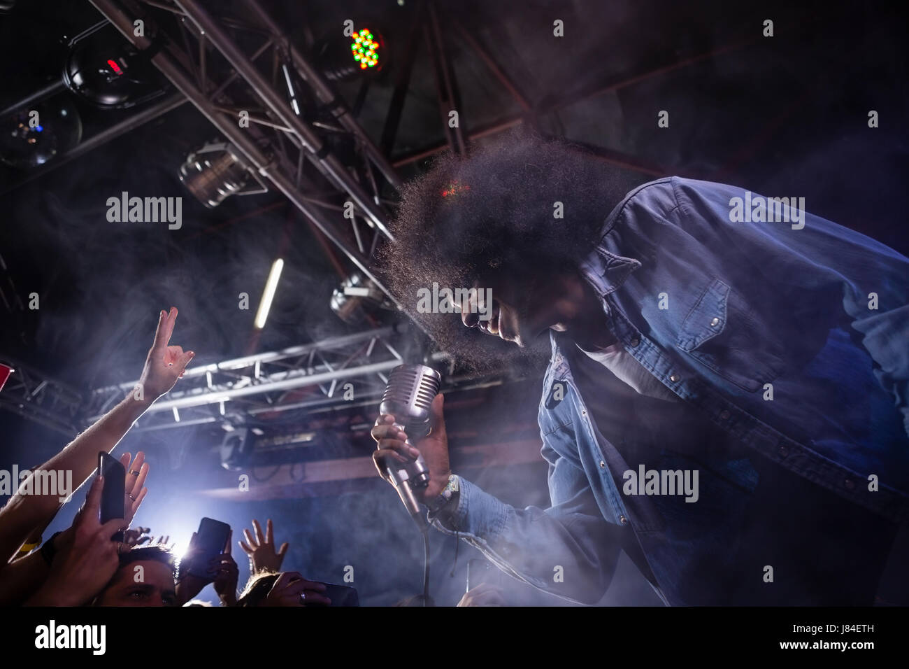 Singer performing on stage in nightclub Stock Photo - Alamy