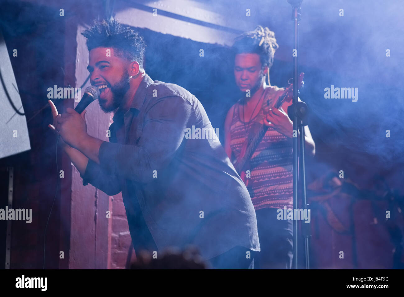 Singer performing on stage in nightclub Stock Photo - Alamy