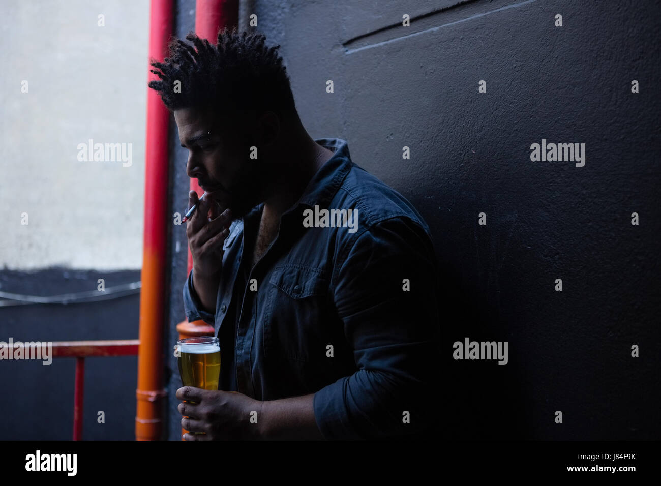 Man smoking cigarette at bar hi-res stock photography and images - Alamy
