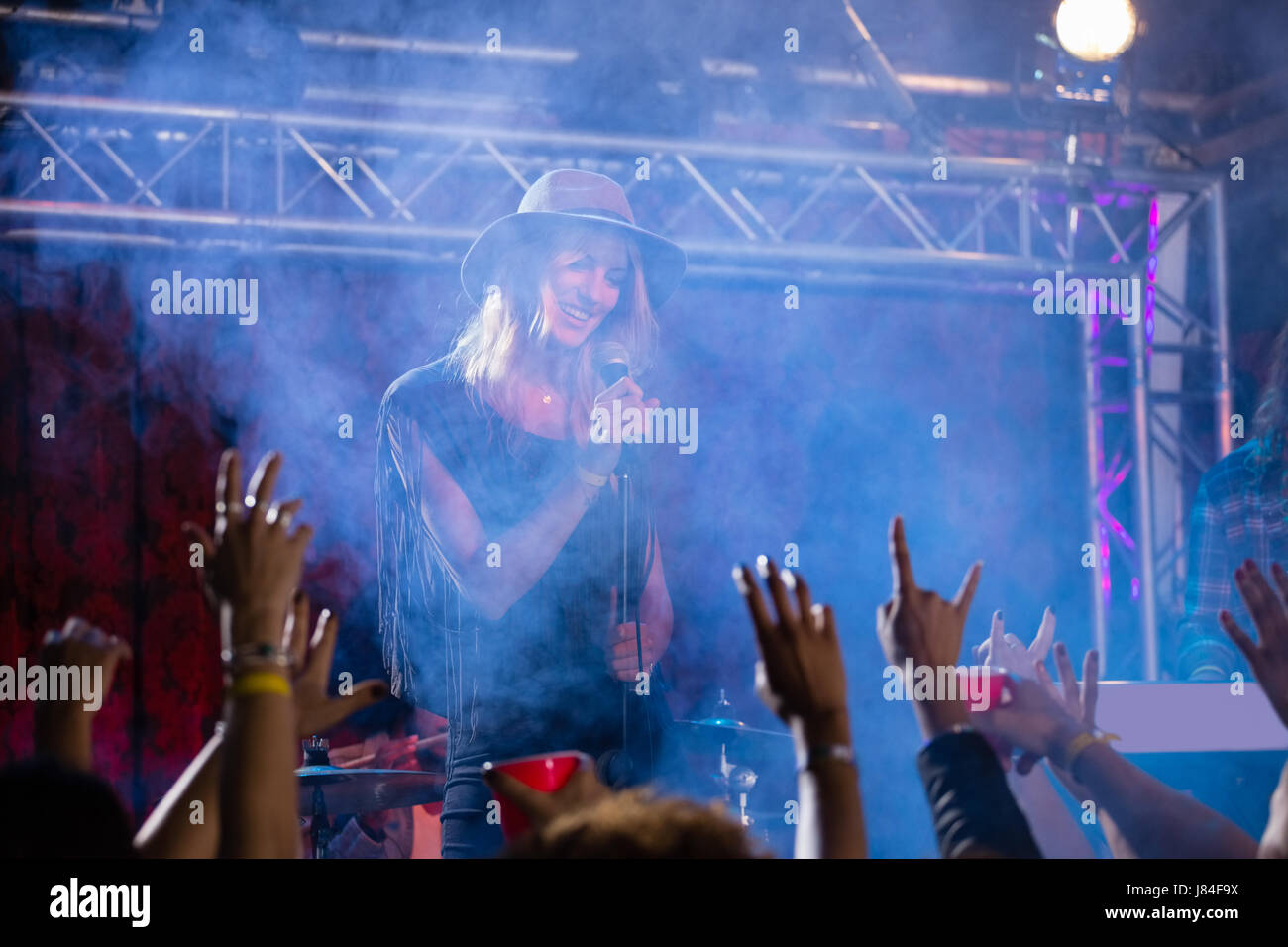 Singer performing on stage in nightclub Stock Photo - Alamy