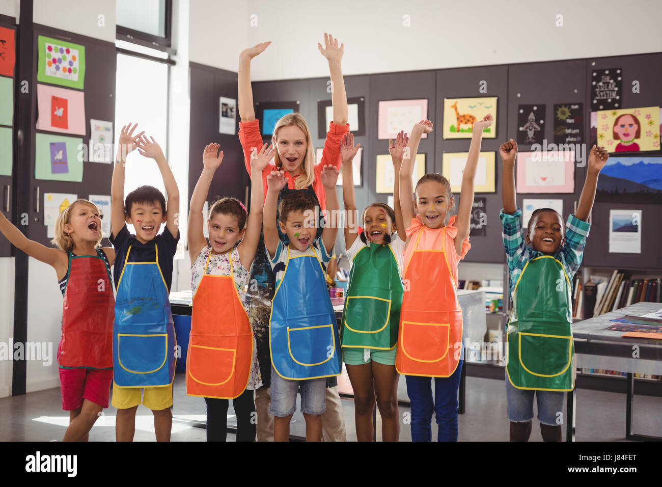 Portrait of teacher and schoolkids having fun in drawing class Stock ...