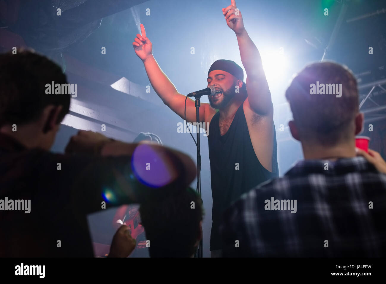 Singer performing on stage in nightclub Stock Photo - Alamy