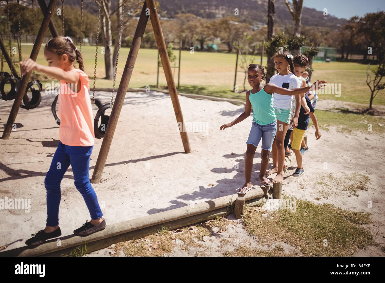 Happy schoolkids playing in playground of school Stock Photo - Alamy