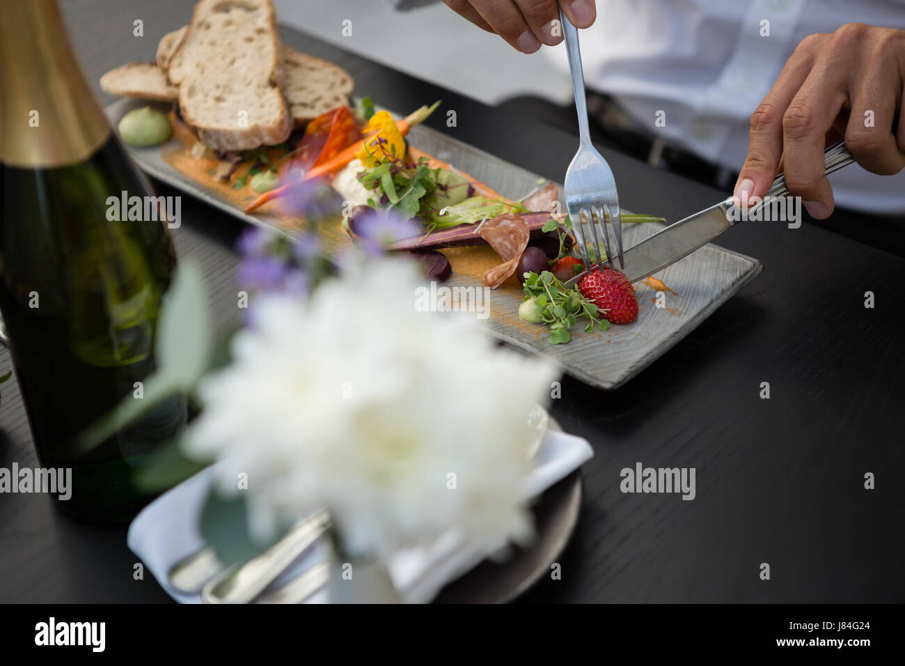 Mid section of man having lunch on table in restaurant Stock Photo - Alamy