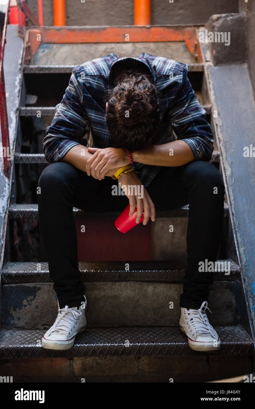 Drunk man sitting alone hi-res stock photography and images - Alamy