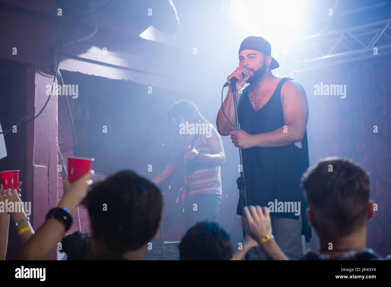 Singer performing on stage in nightclub Stock Photo - Alamy