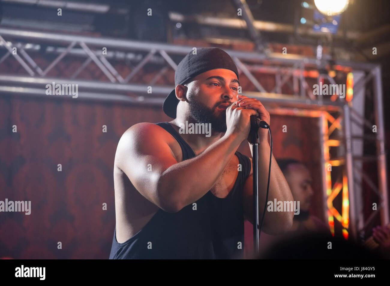 Singer performing on stage in nightclub Stock Photo - Alamy