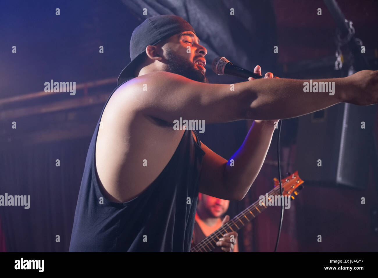 Singer singing on stage in nightclub Stock Photo - Alamy