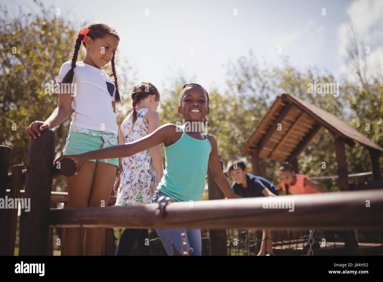 Happy schoolkids playing in playground of school Stock Photo - Alamy