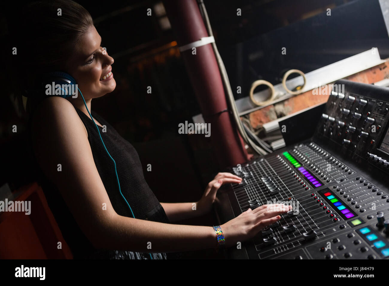 Female audio engineer using sound mixer in recording studio Stock Photo ...