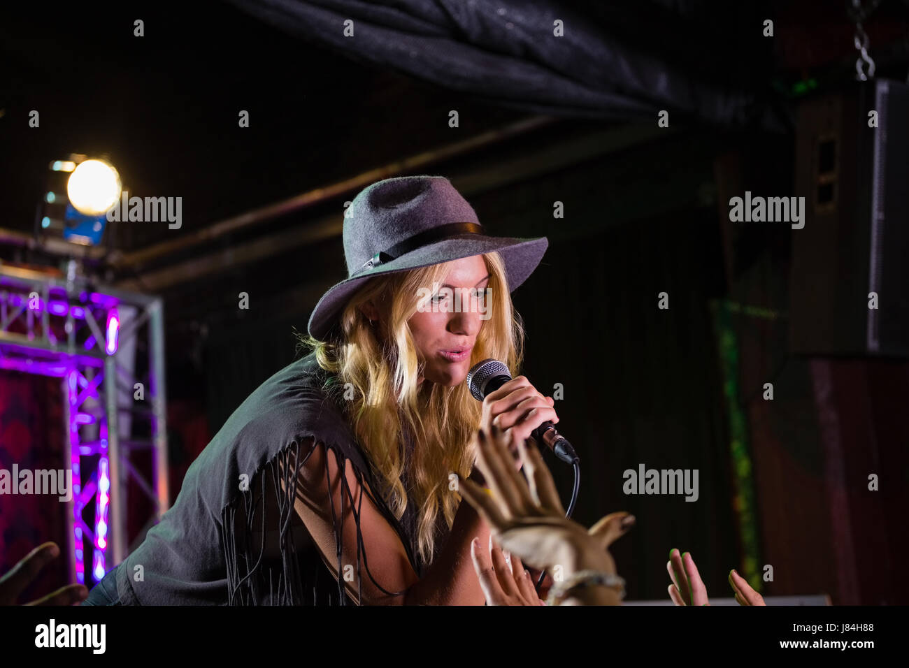 Singer performing on stage in nightclub Stock Photo - Alamy