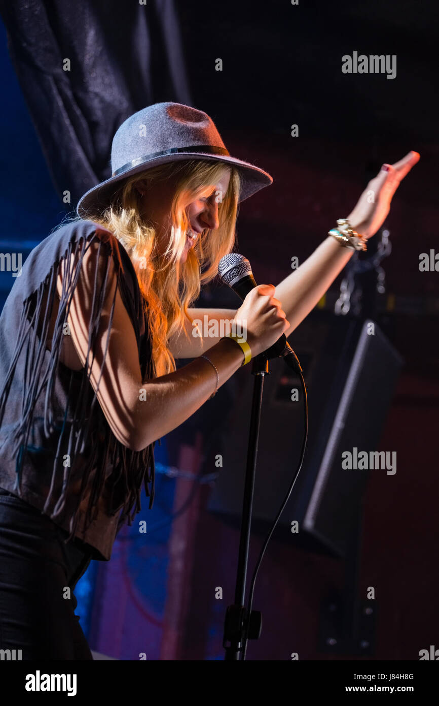 Singer performing on stage in nightclub Stock Photo - Alamy