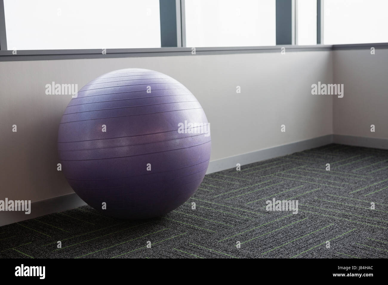 Purple fitness ball in office Stock Photo - Alamy