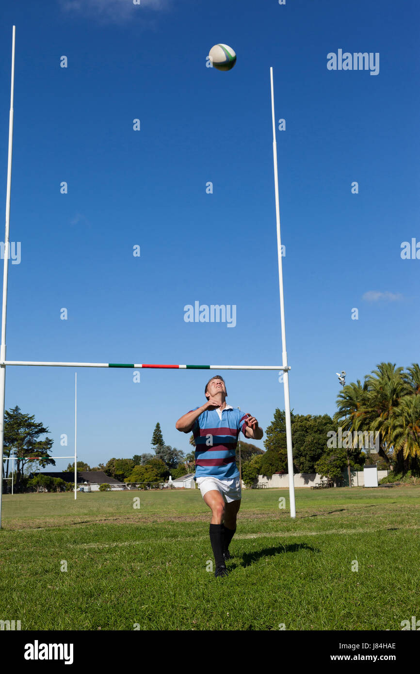 Young man catching ball at goal post hi-res stock photography and ...