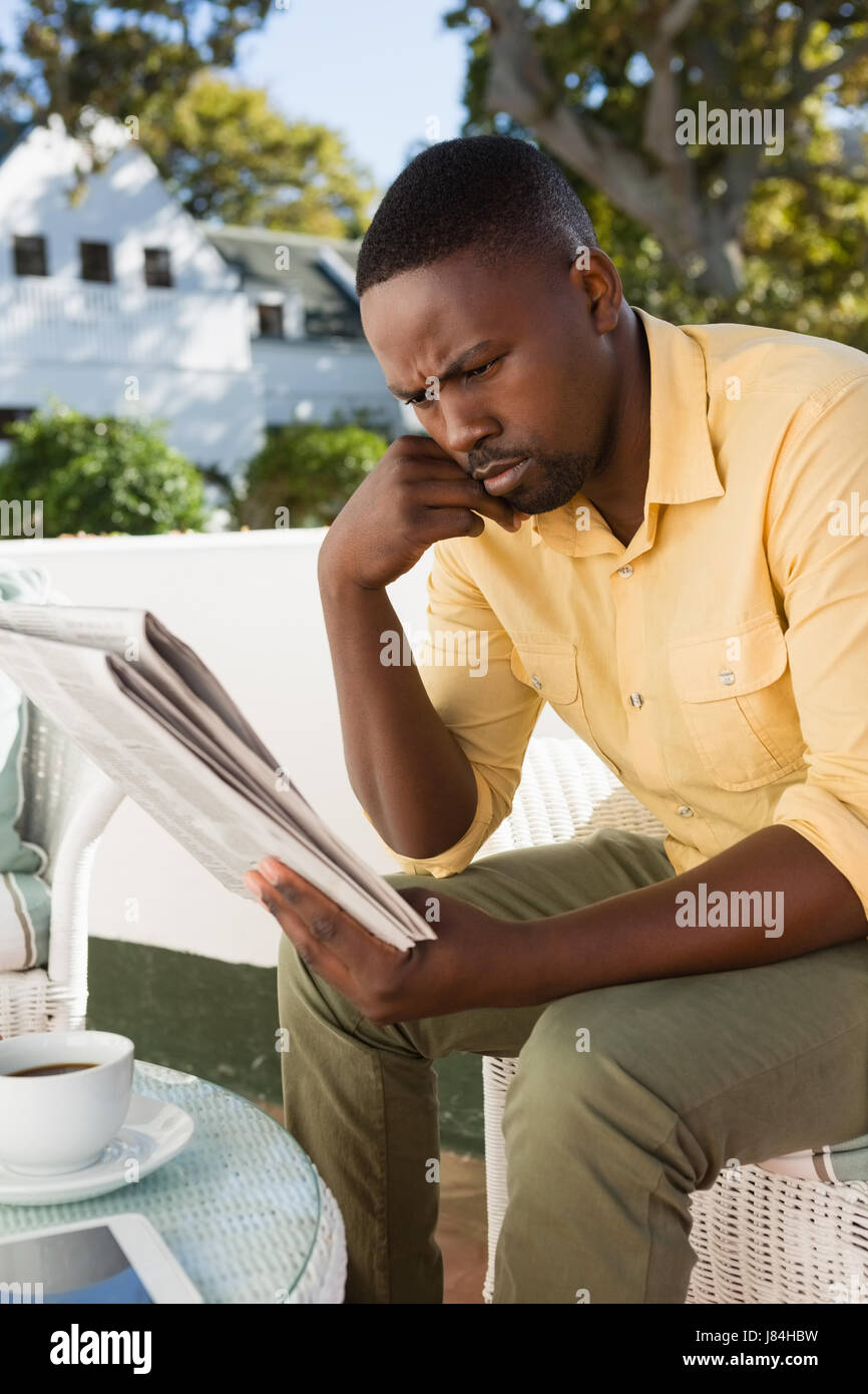 Man reading newspaper while sitting hi-res stock photography and images ...