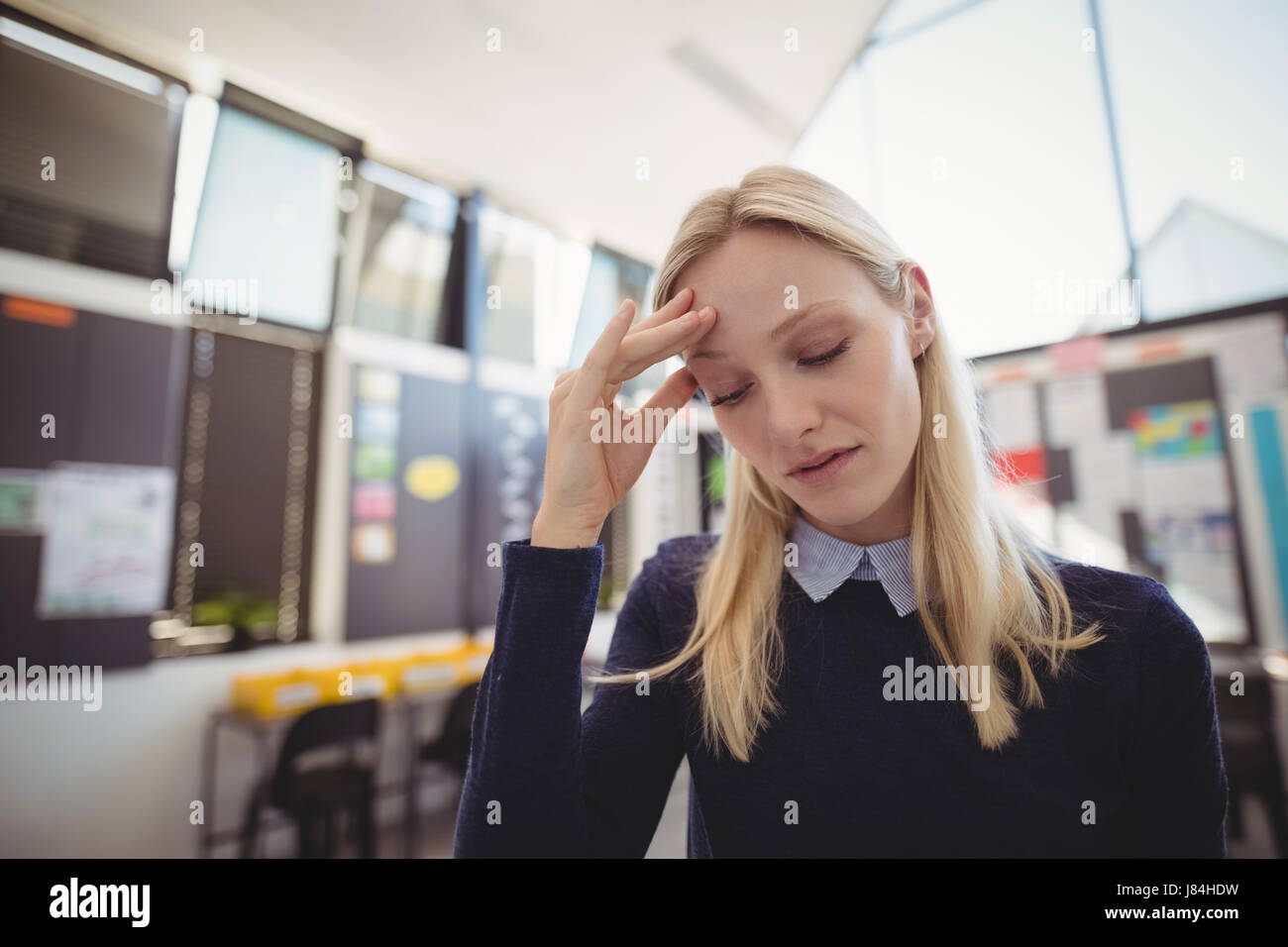 Sad school teacher in classroom at school Stock Photo - Alamy