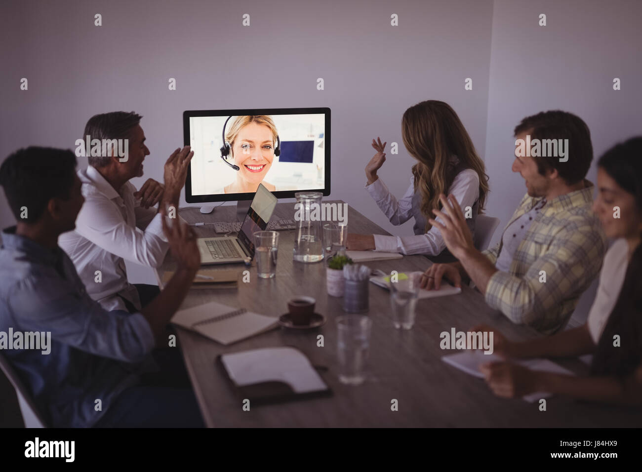 Business people talking to expert through video conference in office ...