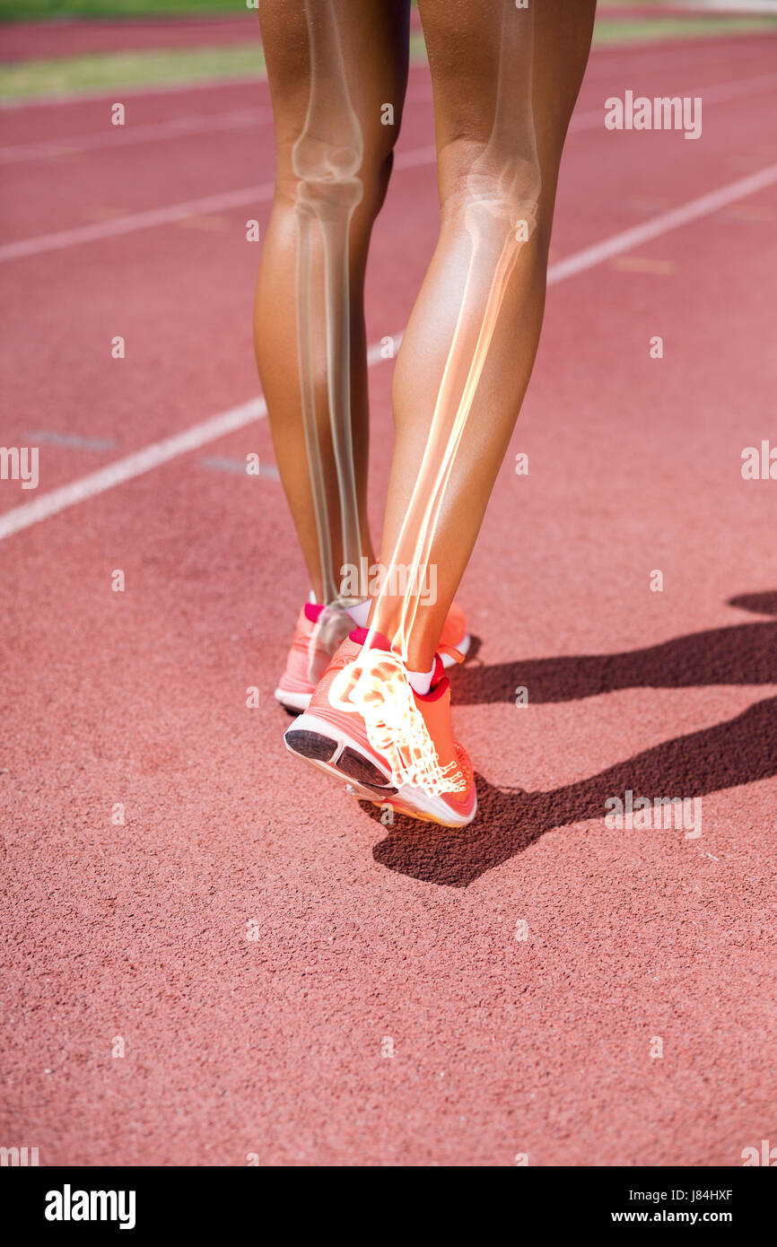 Low section of athlete walking on track during sunny day Stock Photo ...