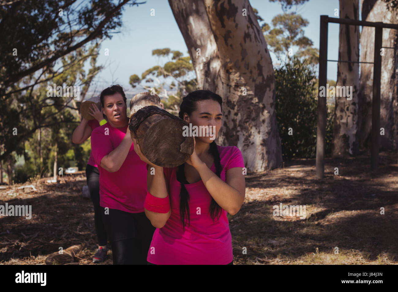 Woman carrying heavy wooden log hi-res stock photography and images - Alamy