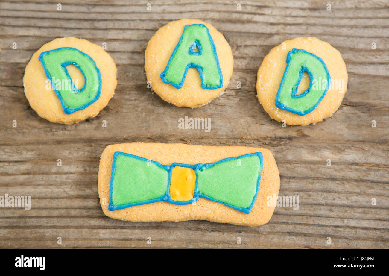 Overhead view of cookies with dad text on wooden table Stock Photo - Alamy