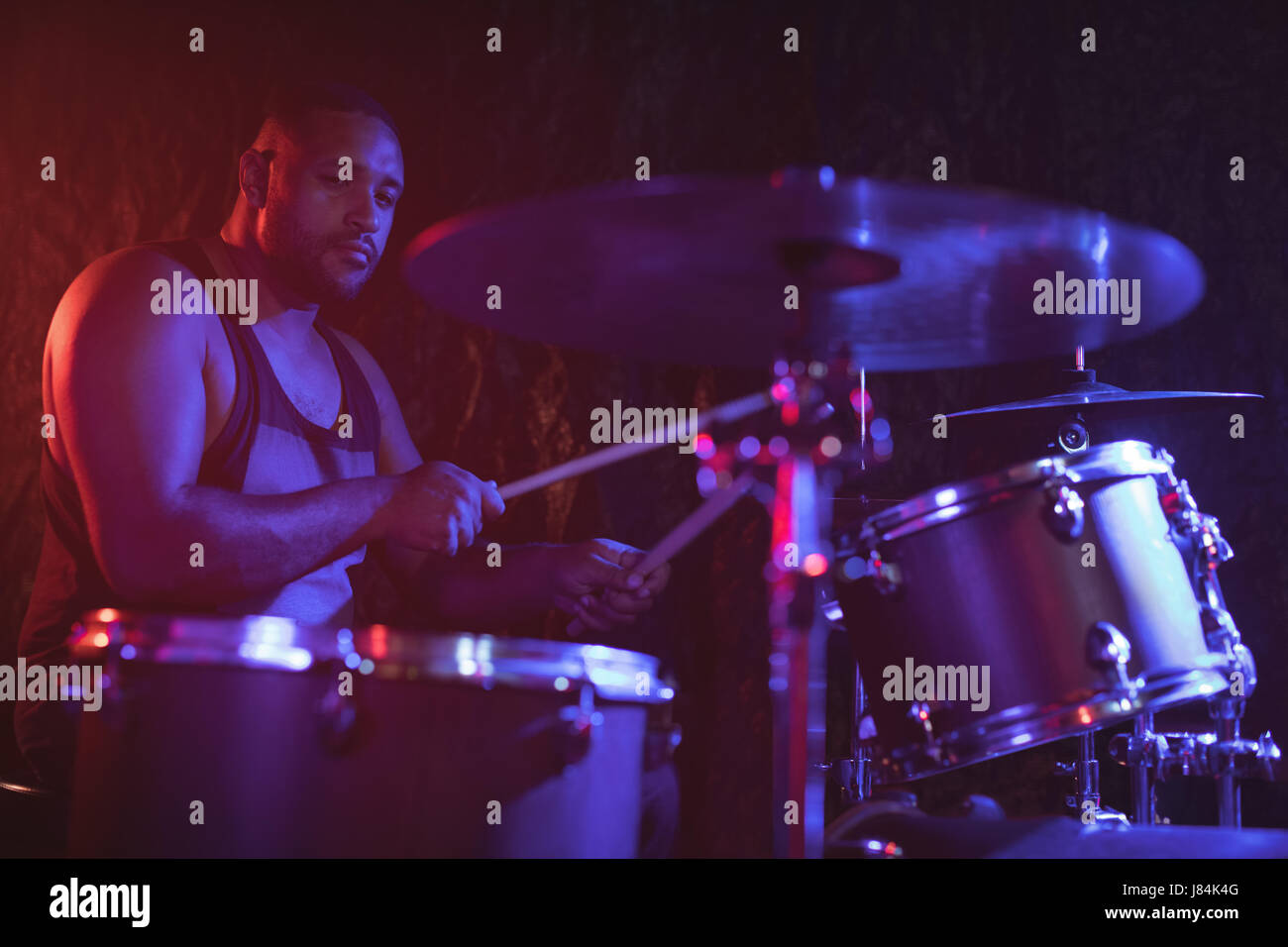 Confident male drummer performing at music concert Stock Photo - Alamy