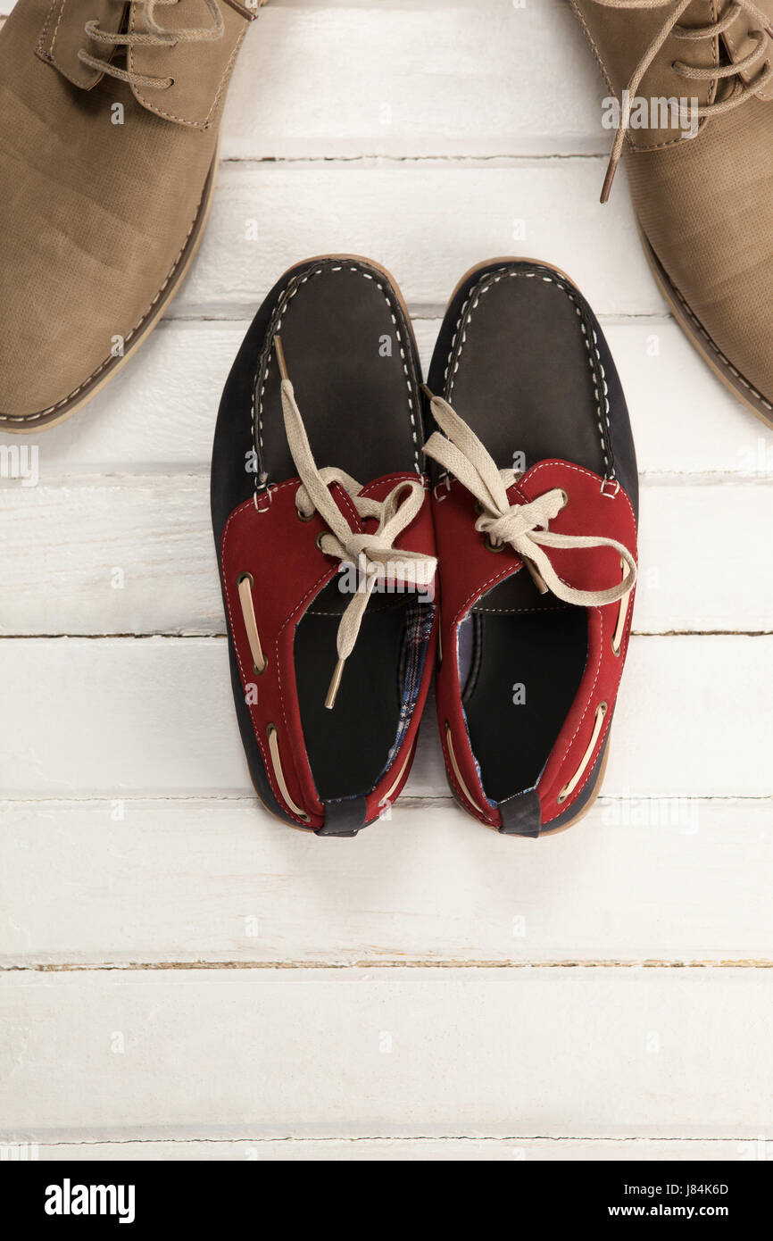 Overhead view of loafers with shoes on wooden white floor Stock Photo ...
