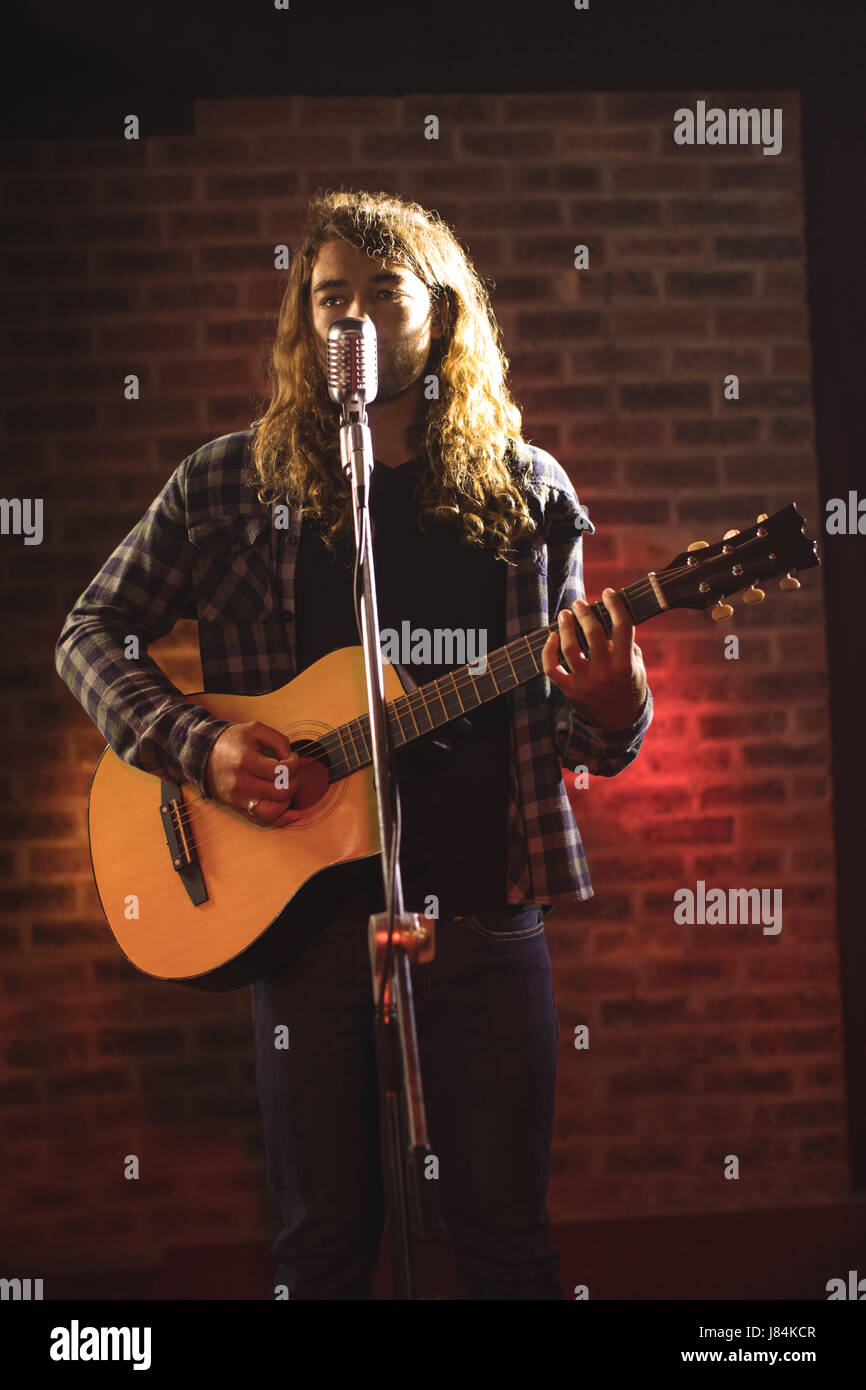 Confident male singer performing in nightclub Stock Photo - Alamy