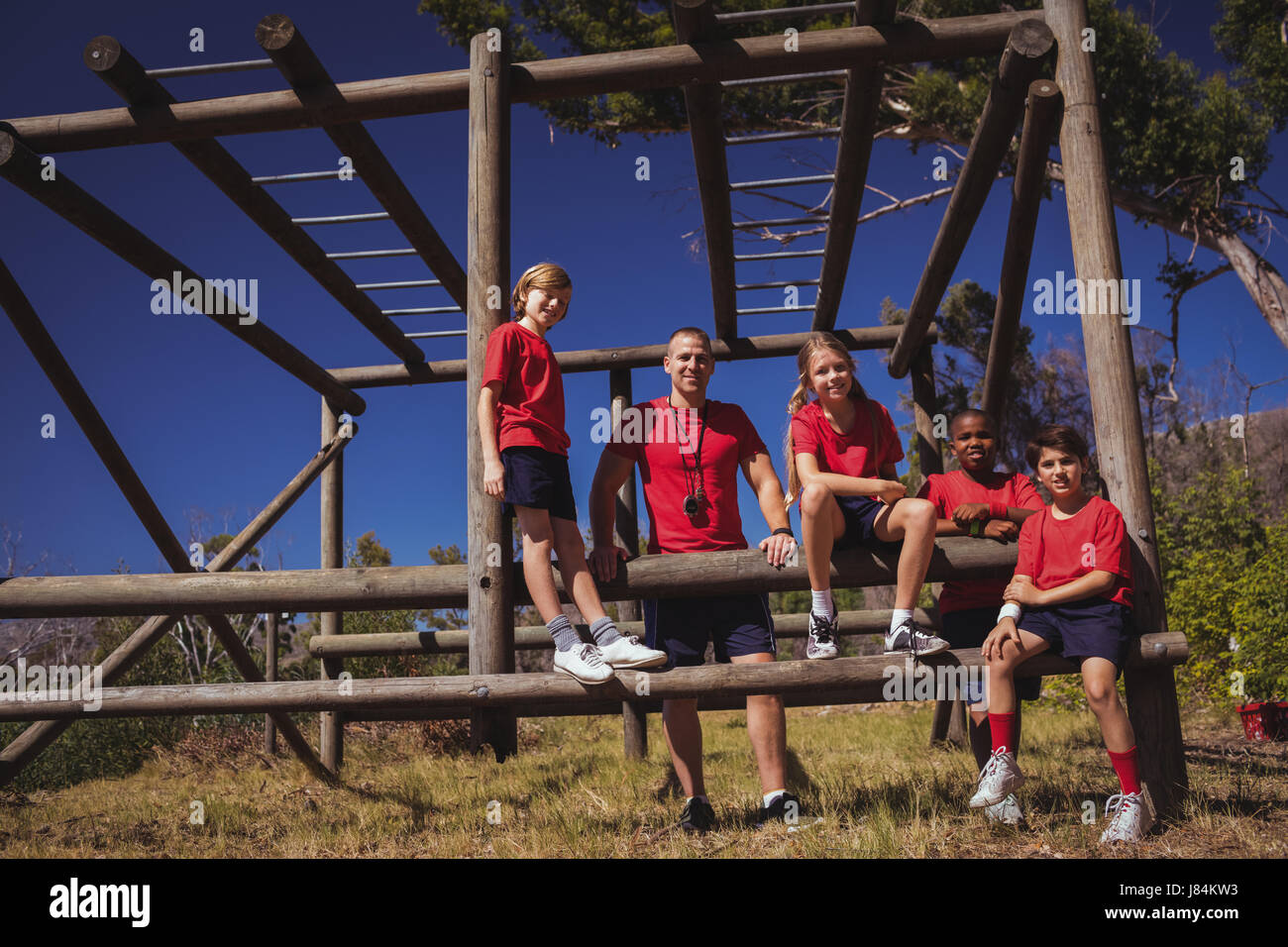 Portrait of trainer and kids relaxing in the boot camp Stock Photo - Alamy