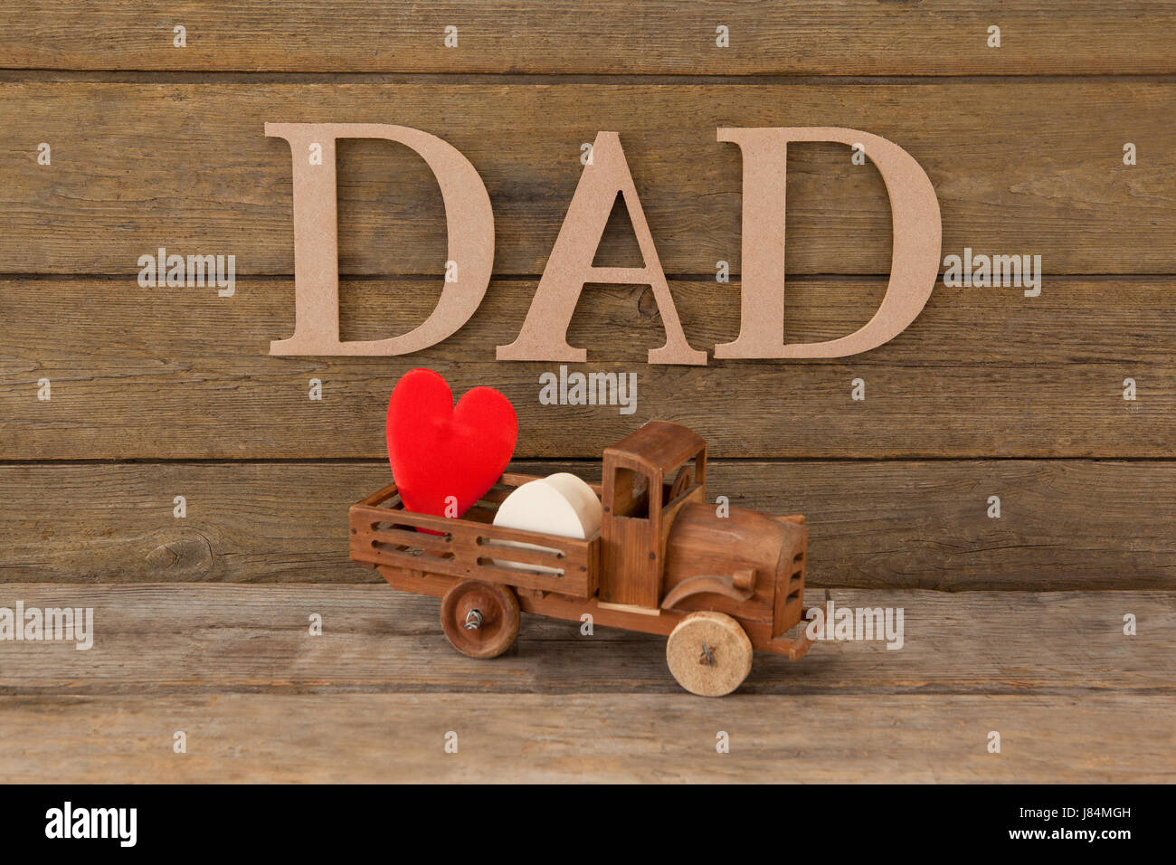 Dad text by heart shape in toy truck on wooden table Stock Photo - Alamy