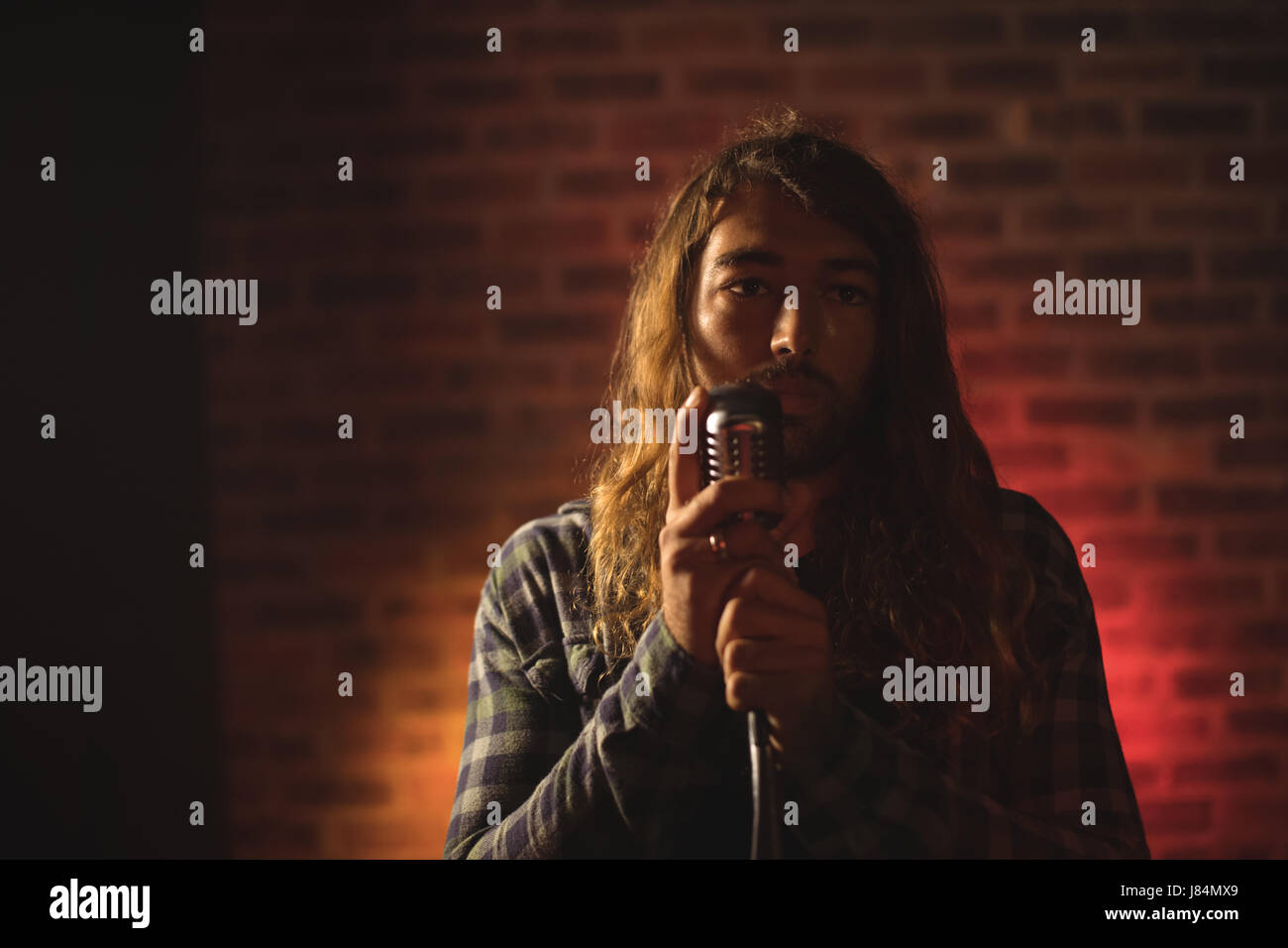 Close up of male singer singing in nightclub Stock Photo - Alamy