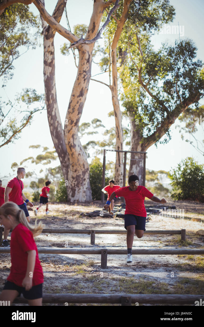 Trainer instructing kids during obstacle course training in the boot ...