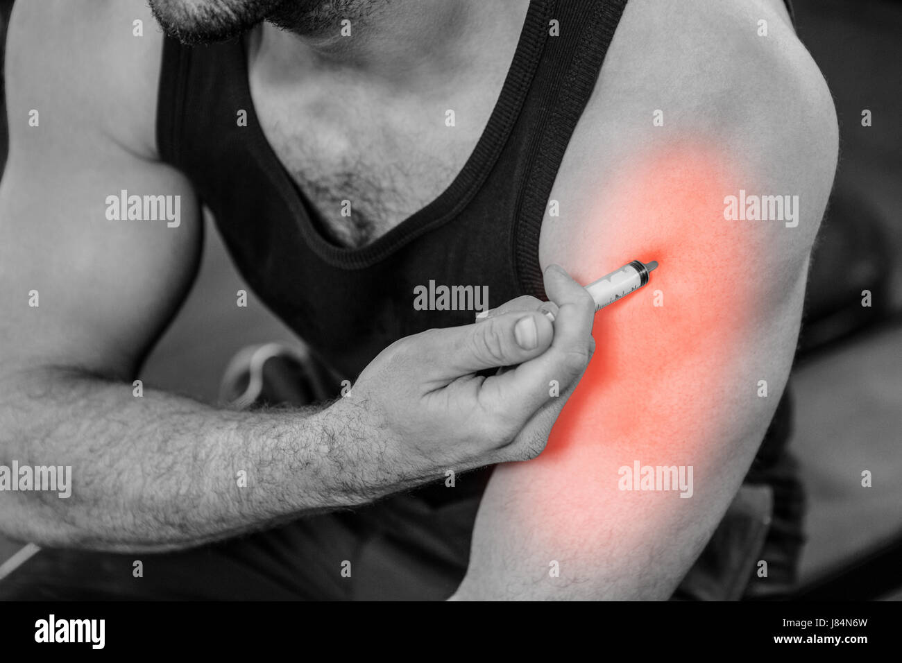 Digital composite of highlighted arm of strong man injecting anabolic ...