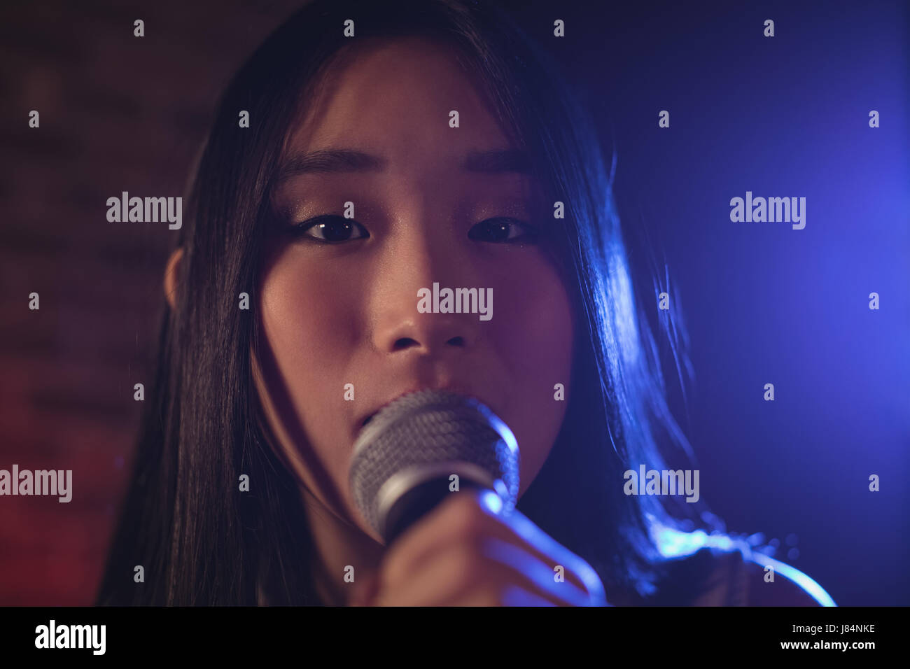 Close up portrait of female singer singing at music concert Stock Photo ...