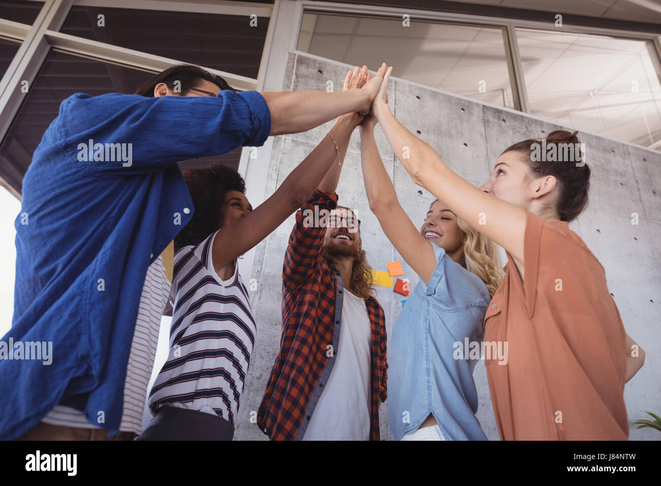 Five people standing with their arms raised hi-res stock photography ...