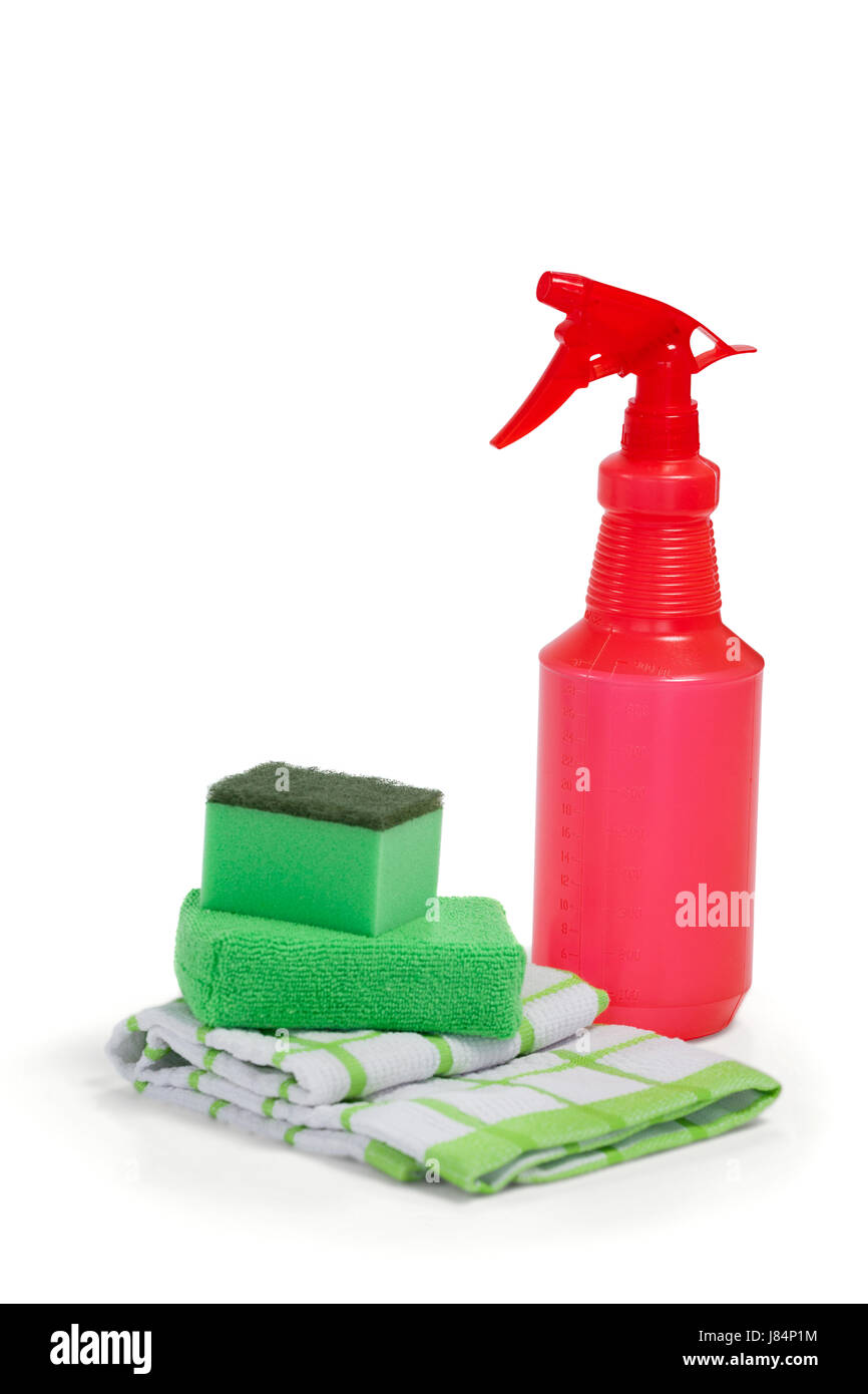 Detergent spray bottle, scouring pad and napkin cloth arranged on white ...