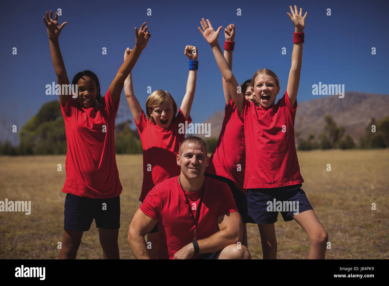Portrait of trainer and kids relaxing in the boot camp Stock Photo - Alamy