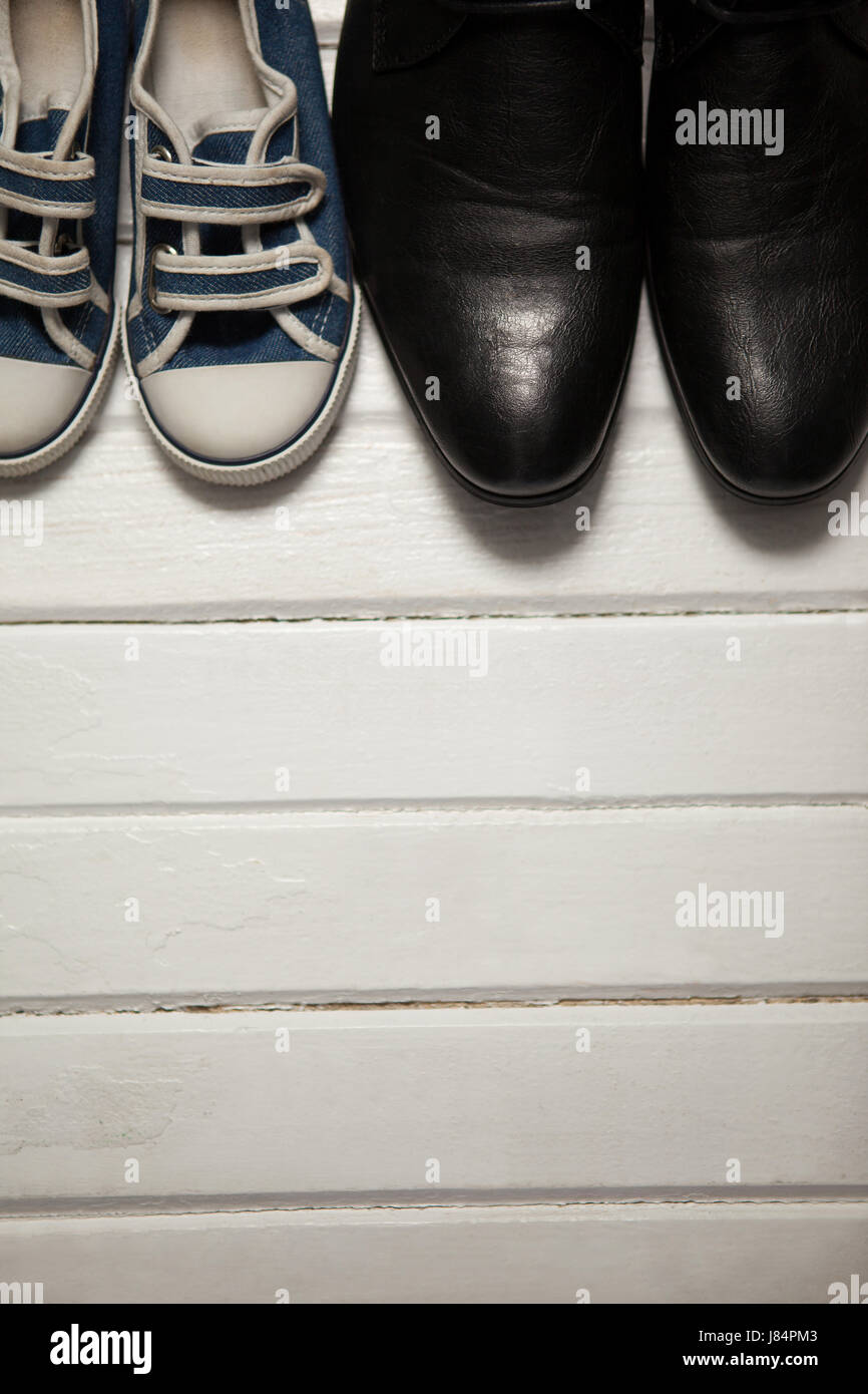 Overhead view of shoes on white wooden floor Stock Photo - Alamy