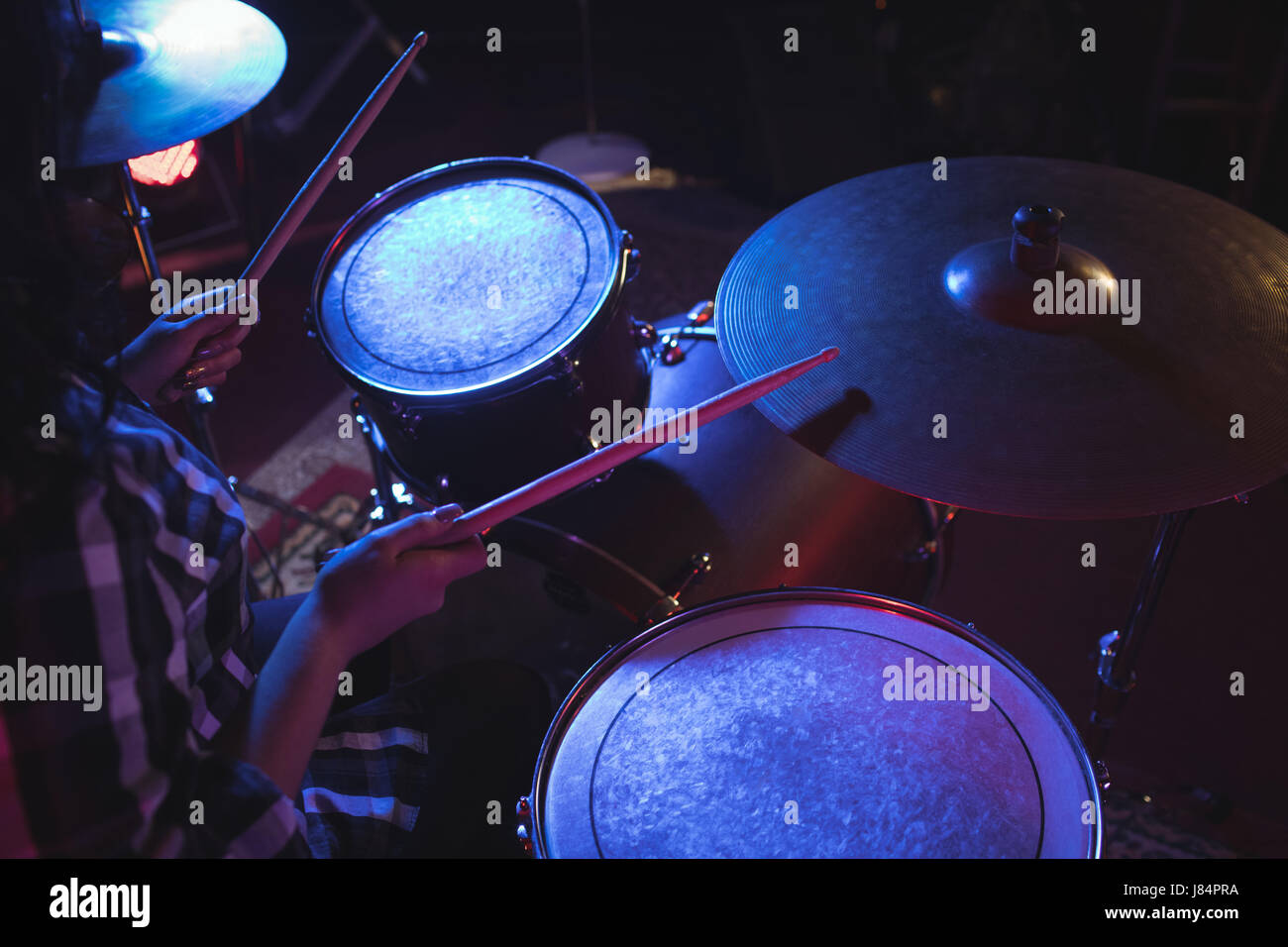 Drummer playing drum kit in nightclub Stock Photo - Alamy