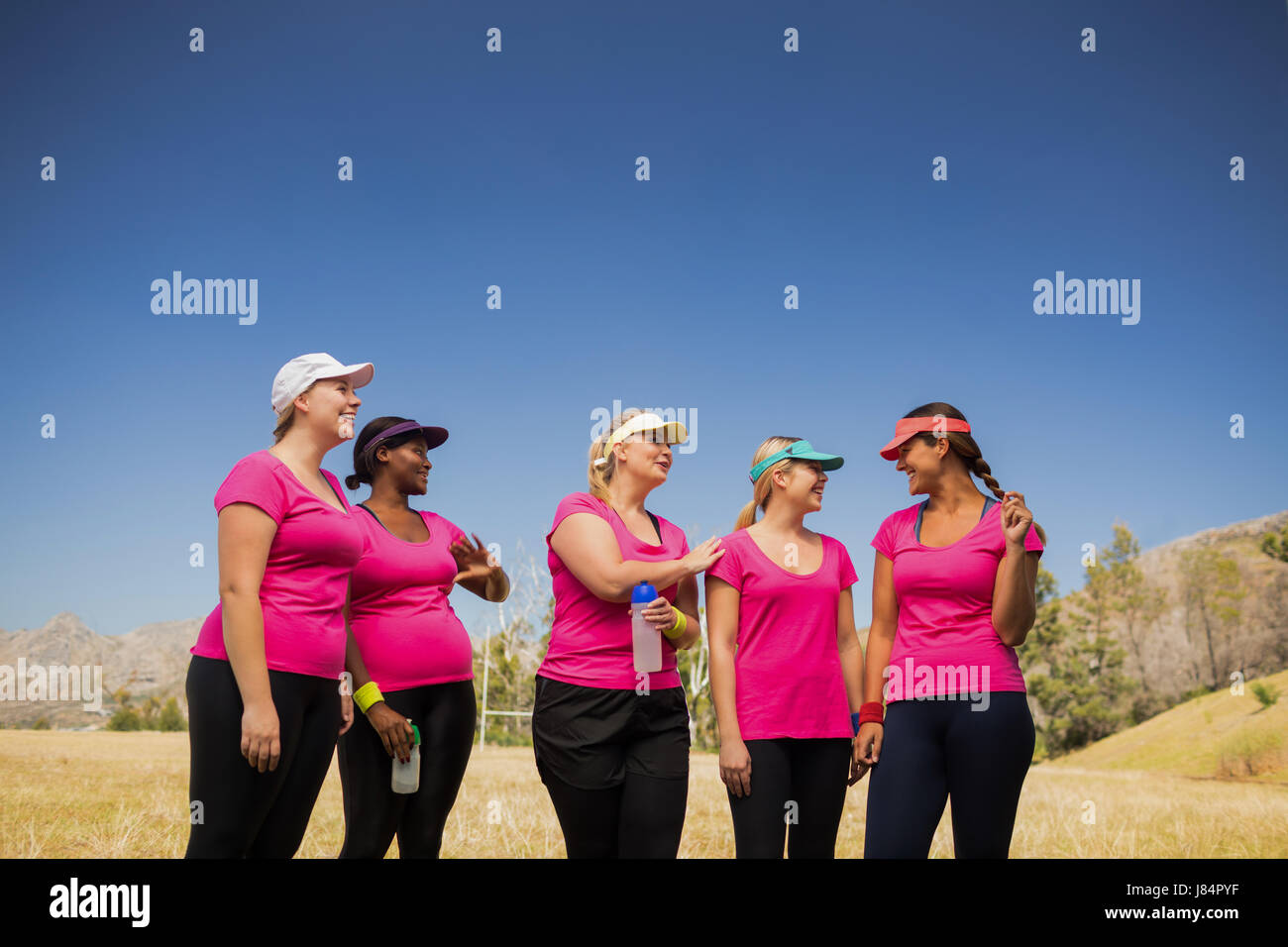 Group of women interacting with each other in the boot camp on a sunny ...