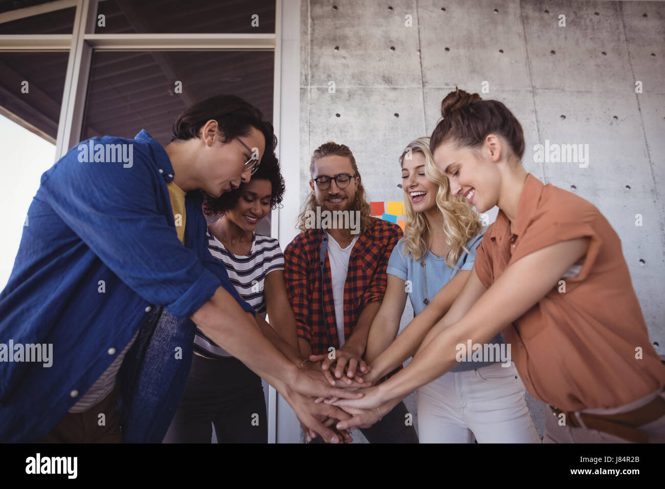 Business people stacking hands hi-res stock photography and images - Alamy