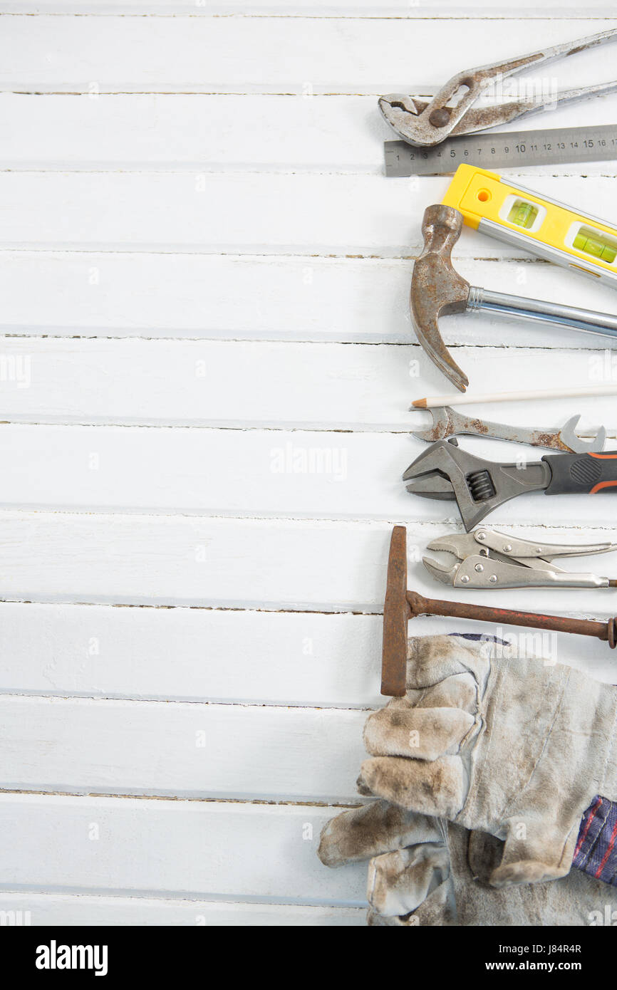 Overhead view of work tools on white wooden table Stock Photo - Alamy