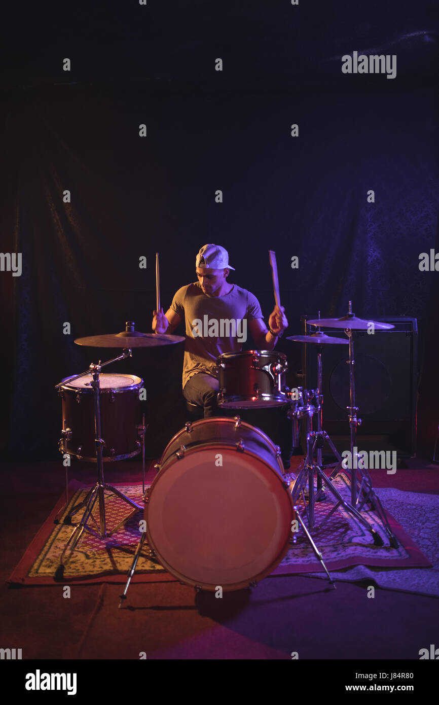 Confident male drummer performing in nightclub Stock Photo - Alamy
