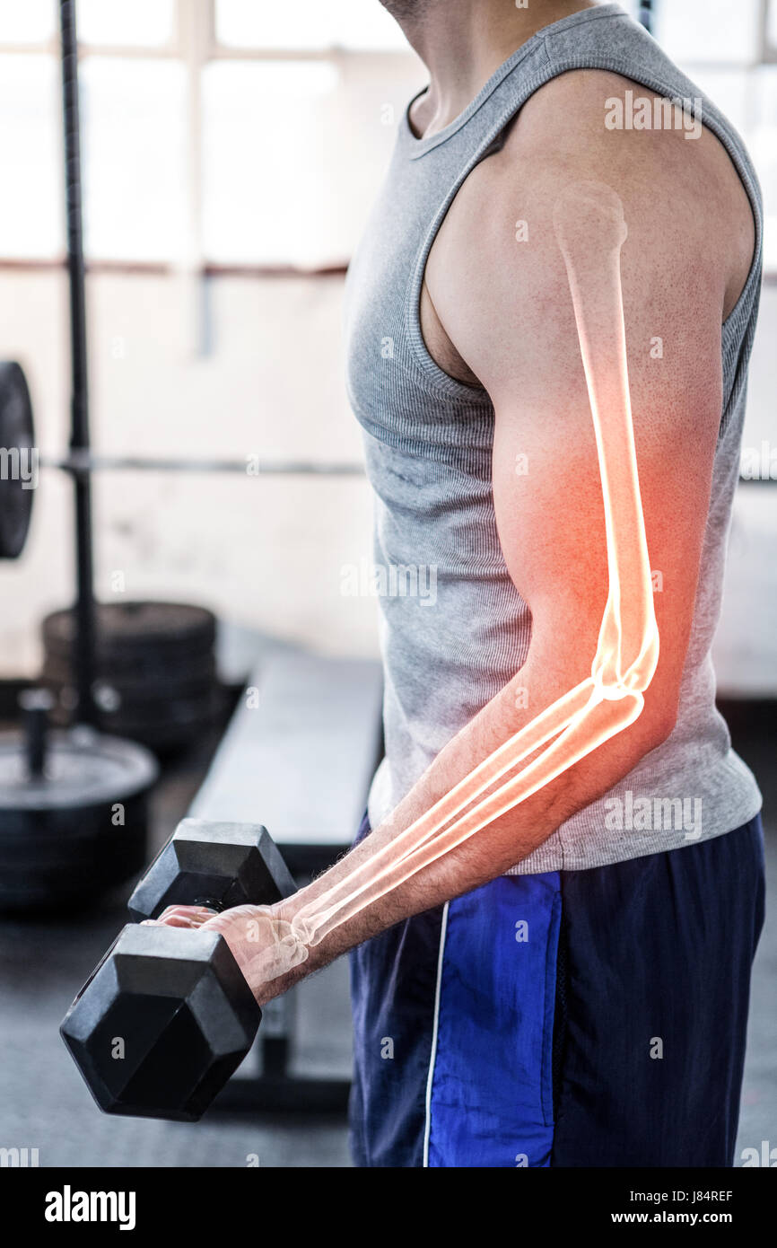 Digital composite of highlighted arm of strong man lifting weights at ...