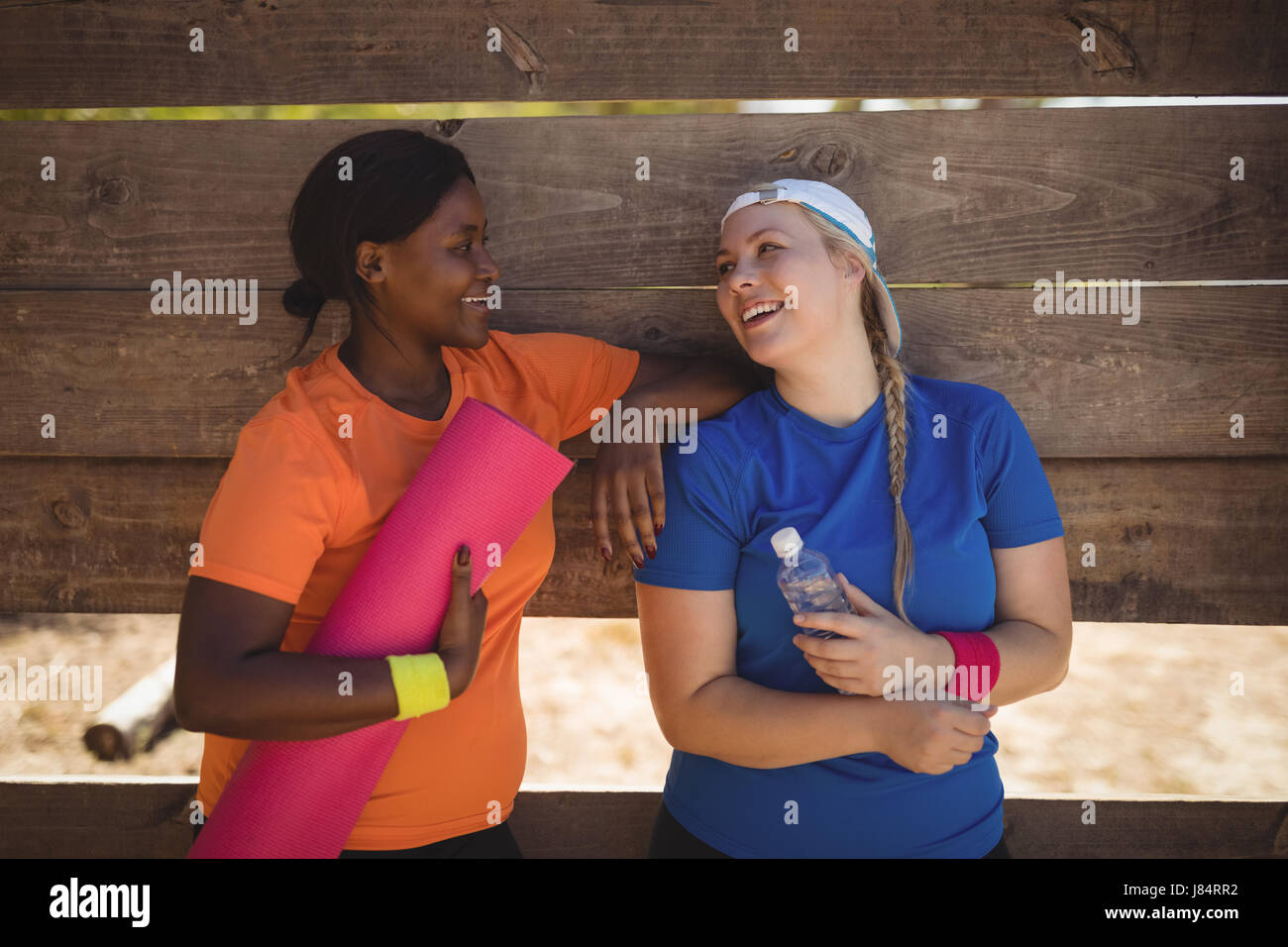 Friends interacting with each other after workout during obstacle ...