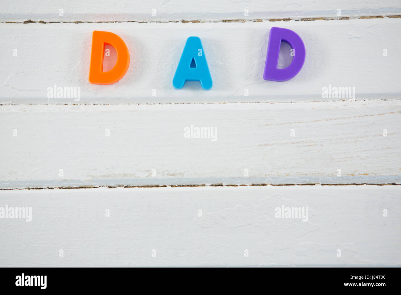 Overhead view of multi colored dad text on white wooden table Stock ...