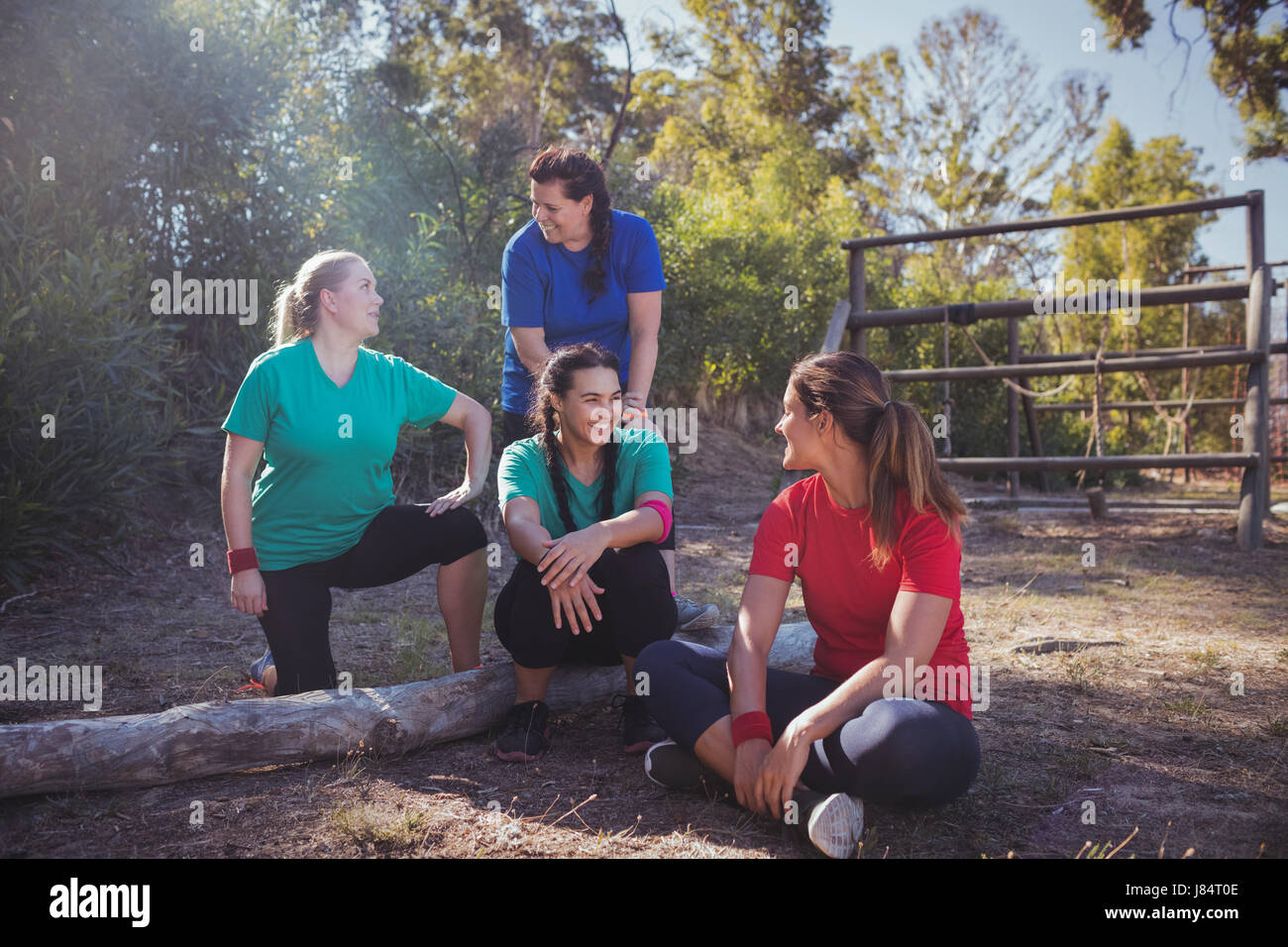 Group of fit women interacting with each other in the boot camp on a ...