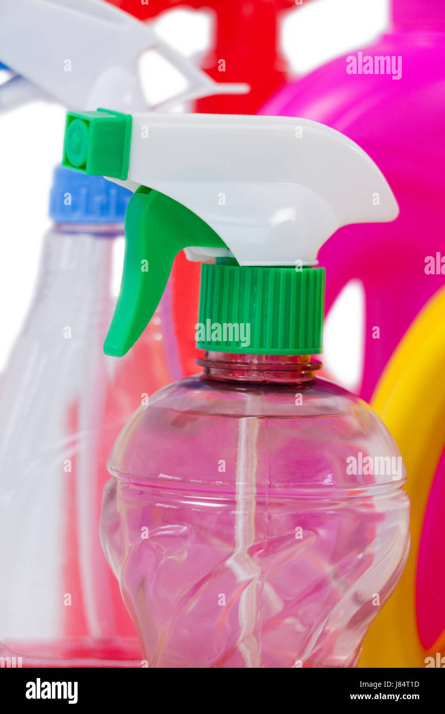 Close-up of detergent spray bottle and containers arranged on white ...